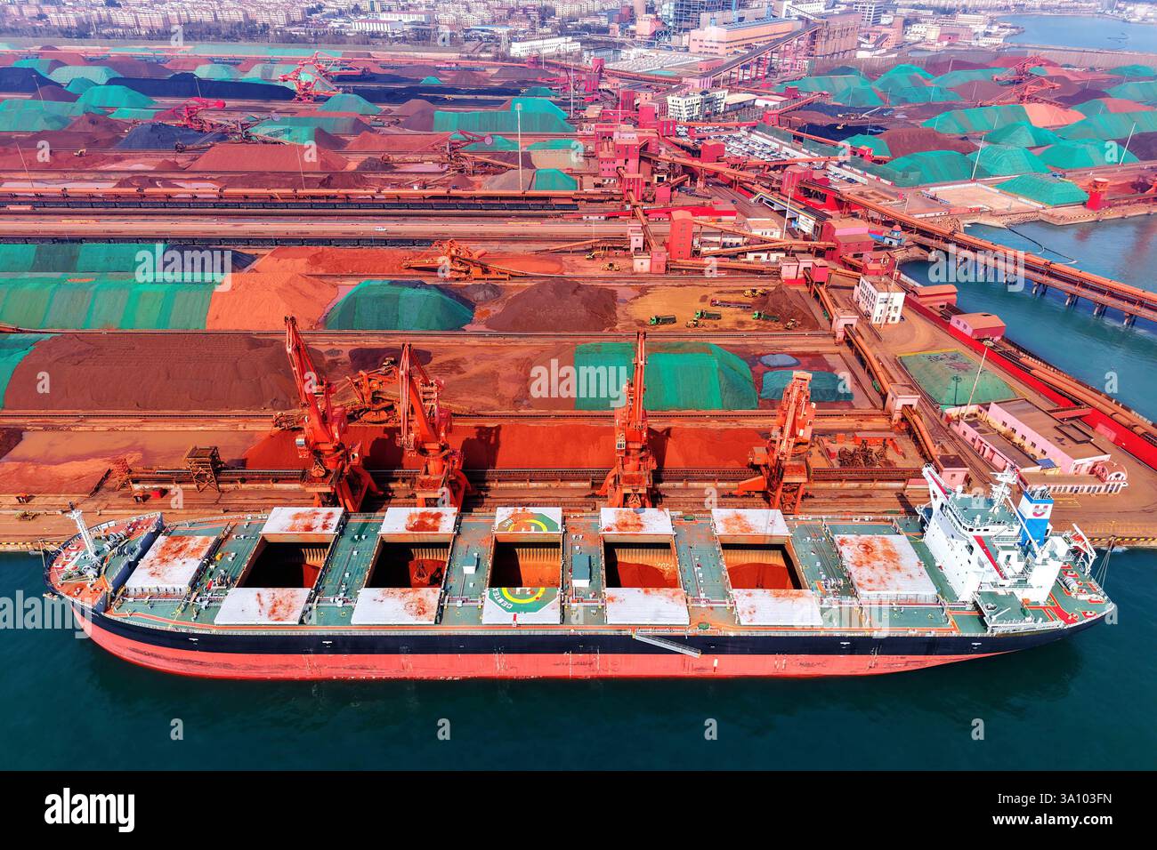 QINGDAO, CHINA - MARCH 6, 2025 - A cargo ship offloads imported iron ...