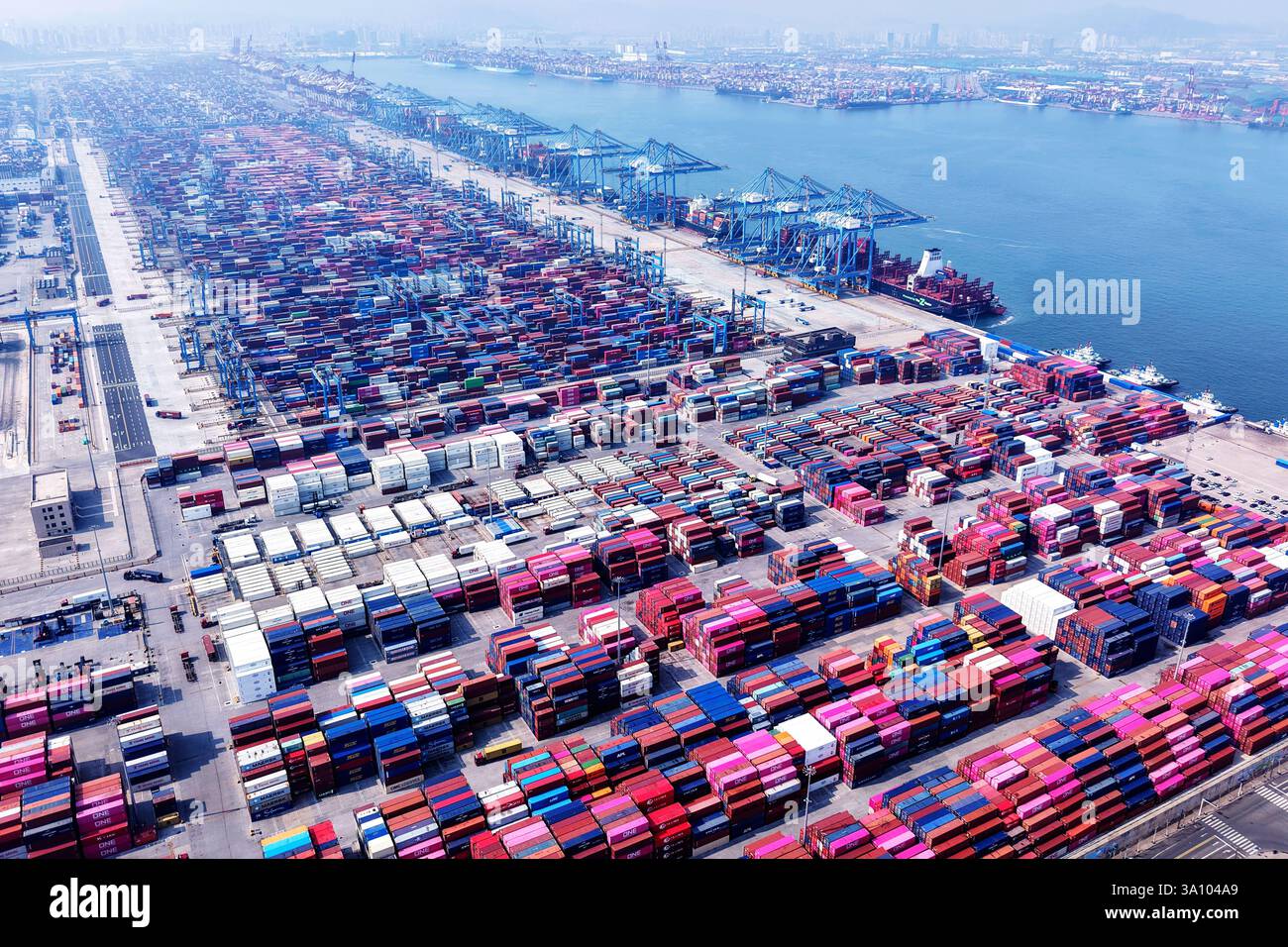 QINGDAO, CHINA - MARCH 6, 2025 - Cargo ships load and unload containers ...