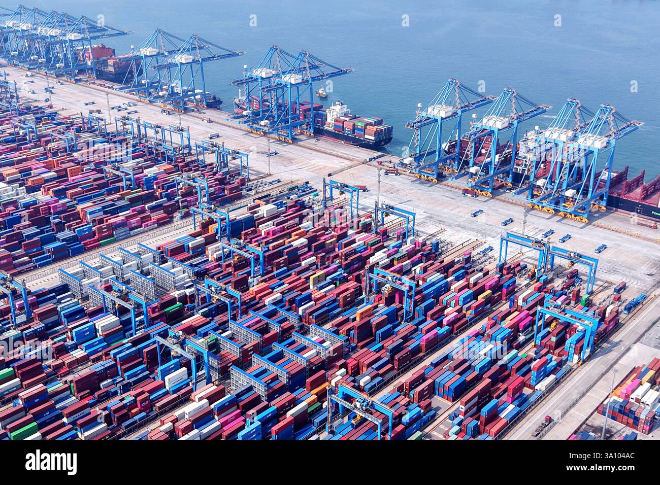QINGDAO, CHINA - MARCH 6, 2025 - Cargo ships load and unload containers ...
