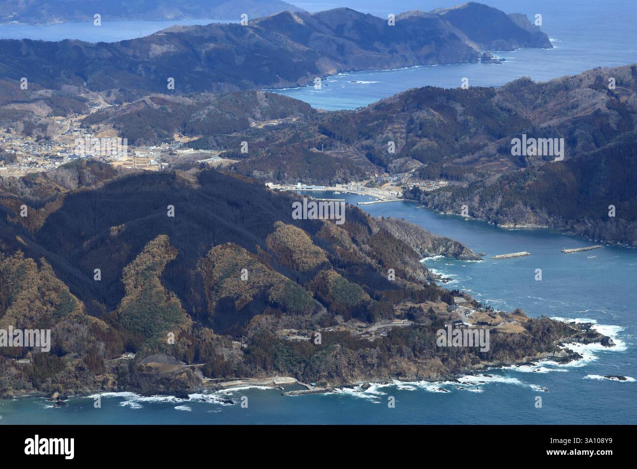 Aerial photo shows the mountain surface scorched black by forest fires ...