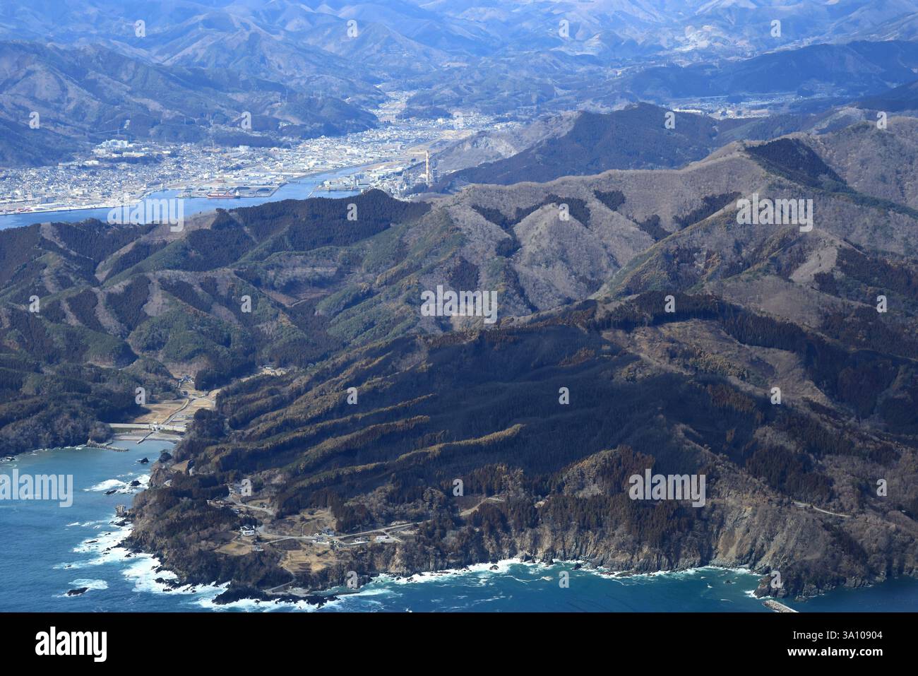 Aerial photo shows the mountain surface scorched black by forest fires ...