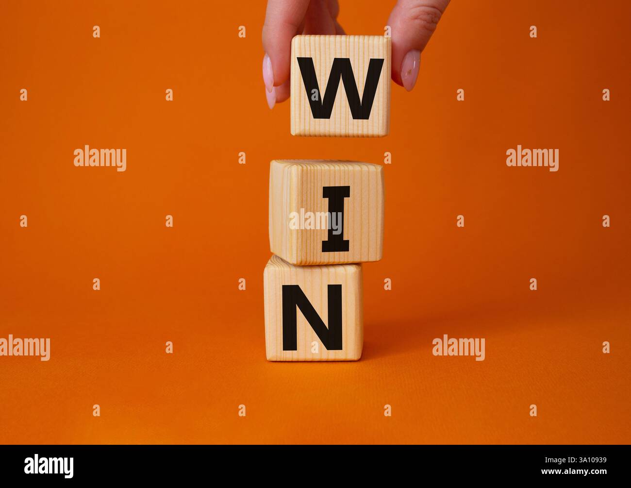 Win symbol. Wooden blocks with words Win. Businessman hand. Beautiful ...