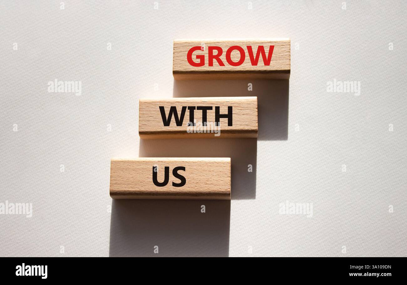 Grow with us symbol. Wooden blocks with words Grow with us. Beautiful ...