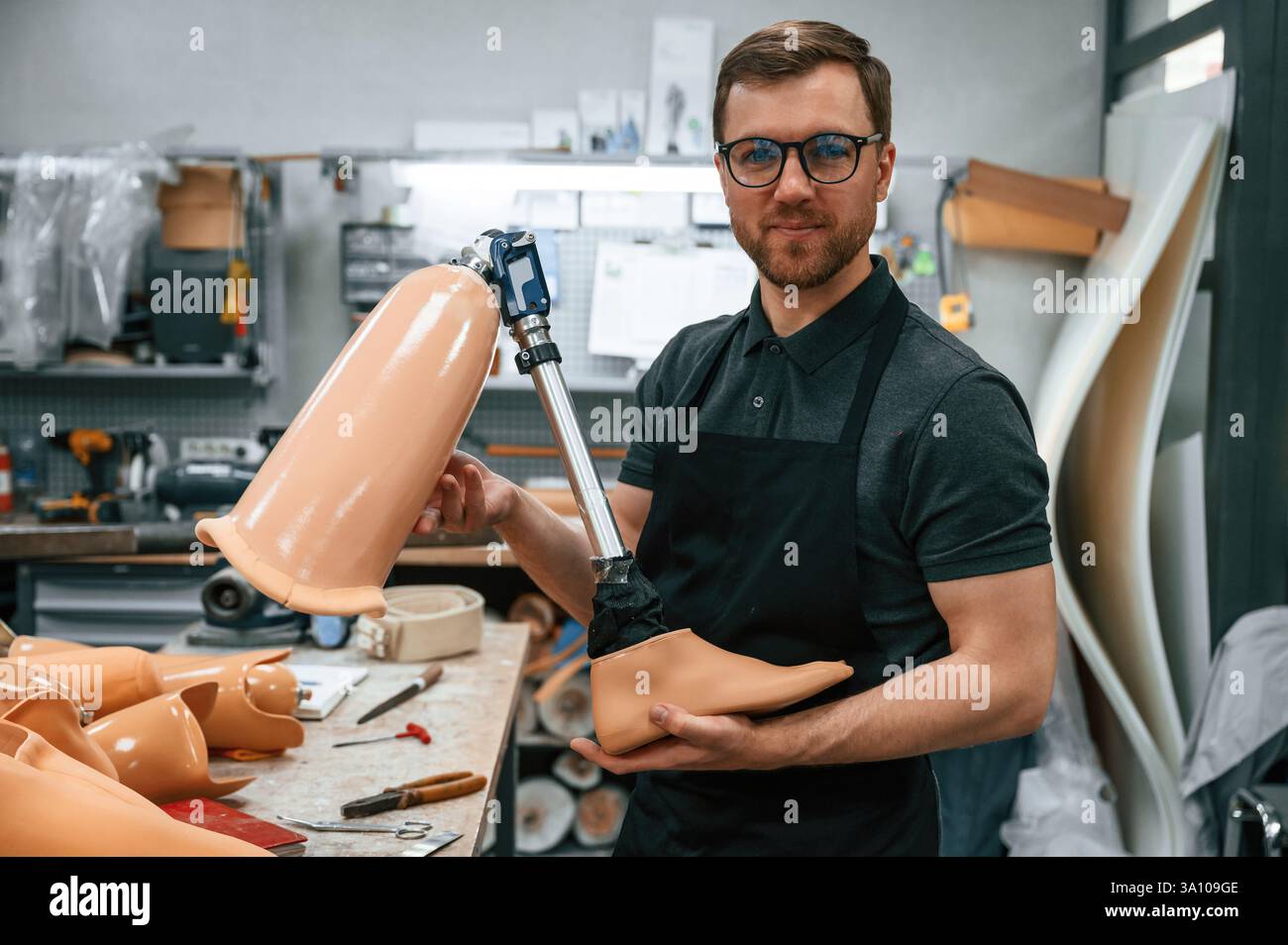 Leg prosthesis in hands. Technician working indoors Stock Photo - Alamy