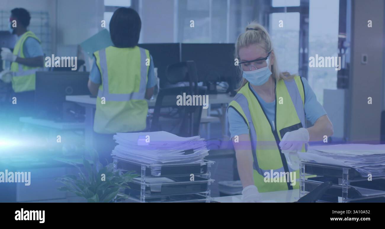 Cleaning office space, workers in safety vests and masks with blue ...