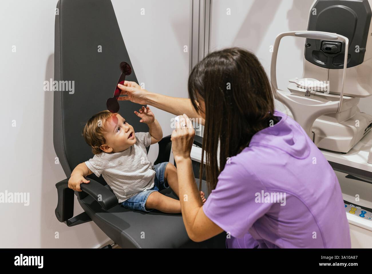 Pediatric optometrist examining vision of baby boy in clinic Stock ...