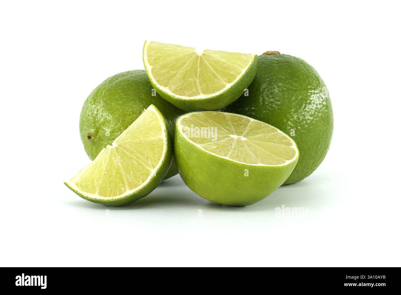 Featuring two whole limes alongside three vibrant lime slices, creating ...