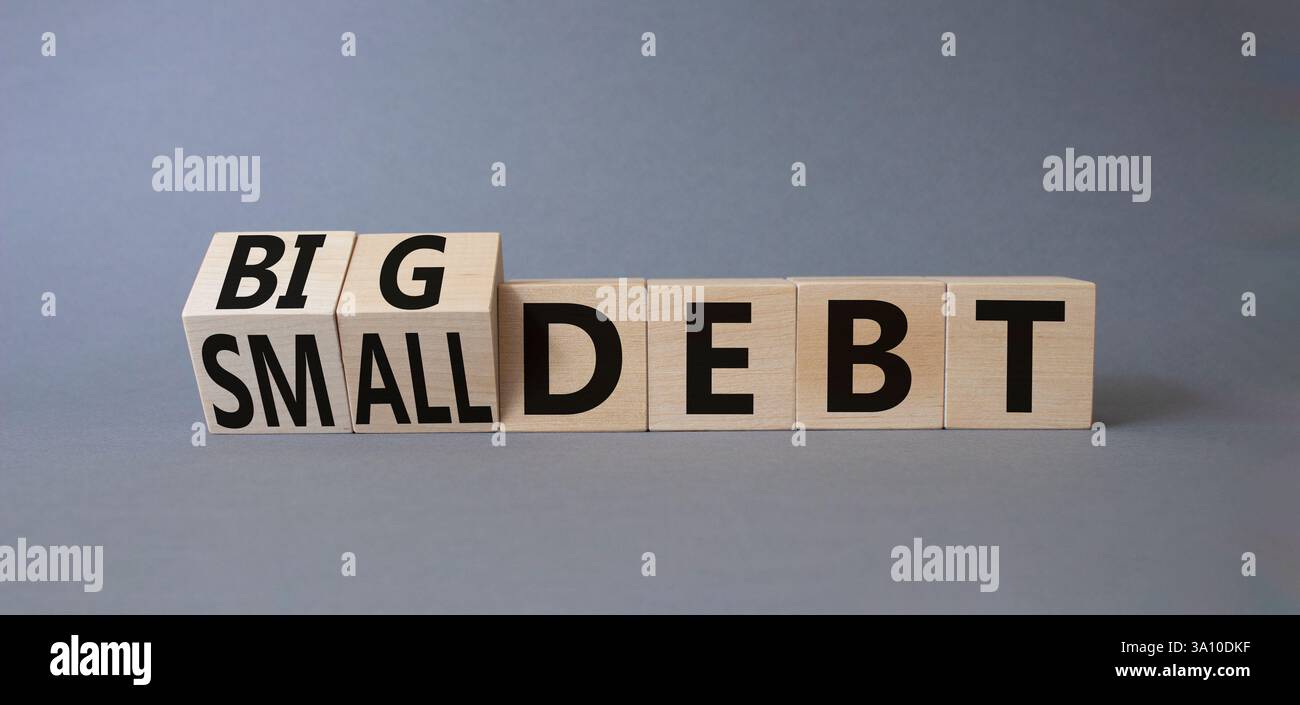 Big debt and small debt symbol. Turned cubes with words Big debt and ...