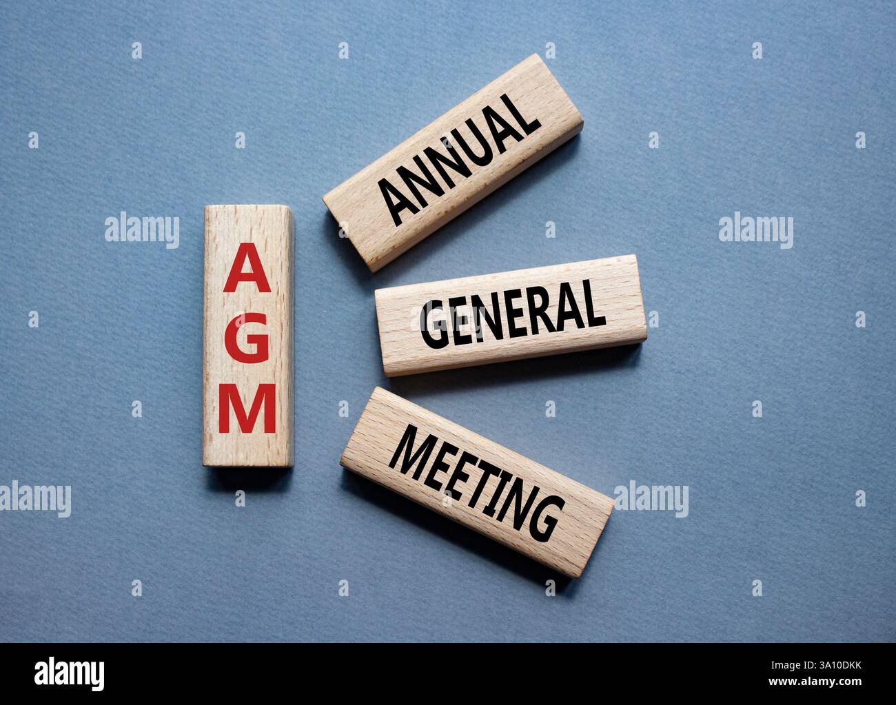 AGM - Annual general meeting symbol. Concept word AGM on wooden blocks ...