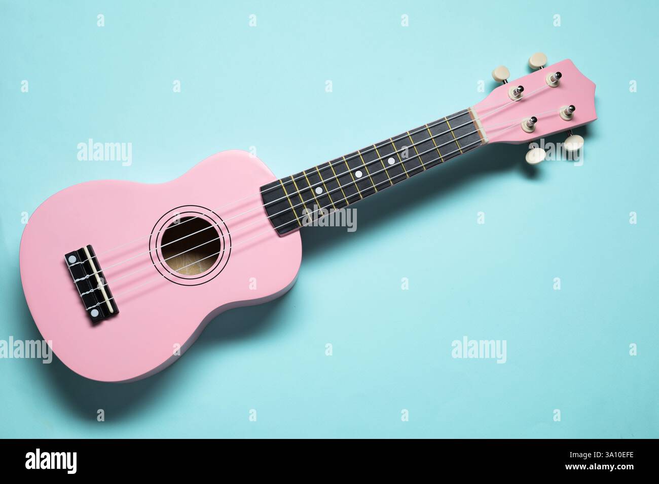 One ukulele on light blue background, top view Stock Photo - Alamy