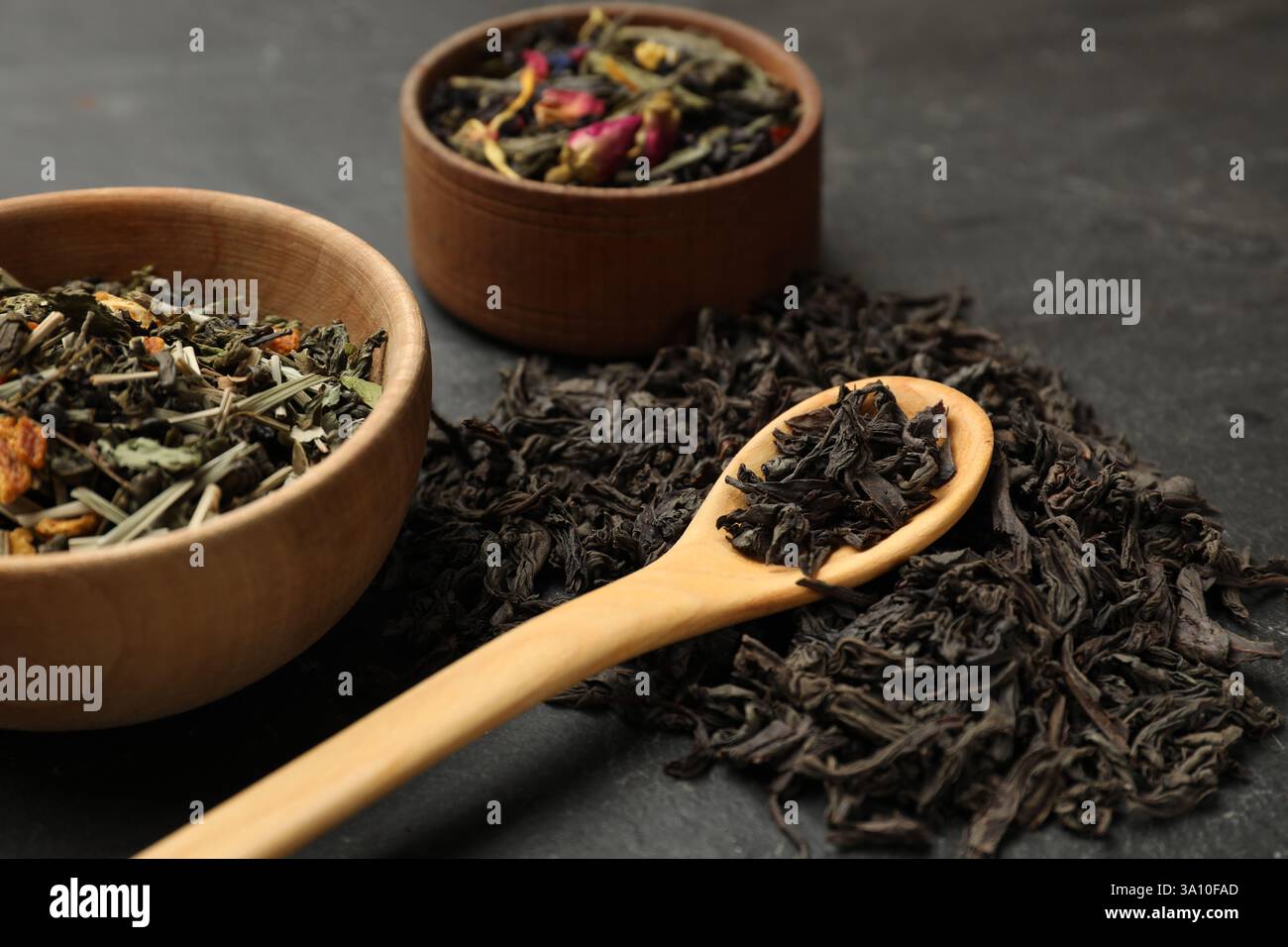 Different types of tea brew on black table, closeup Stock Photo - Alamy