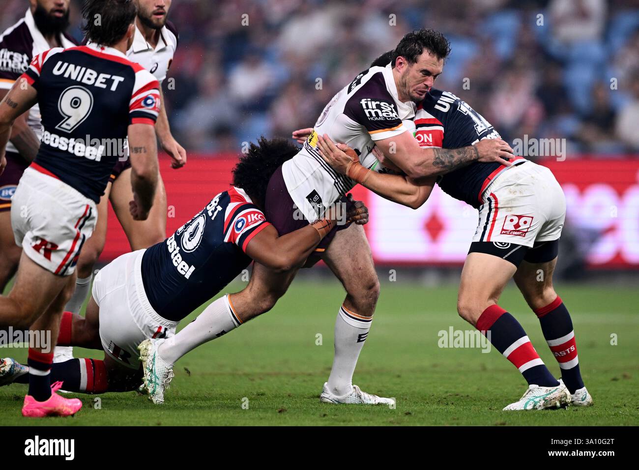 Kobe Hetherington of the Broncos is tackled by Naufahu Whyte (left) and ...
