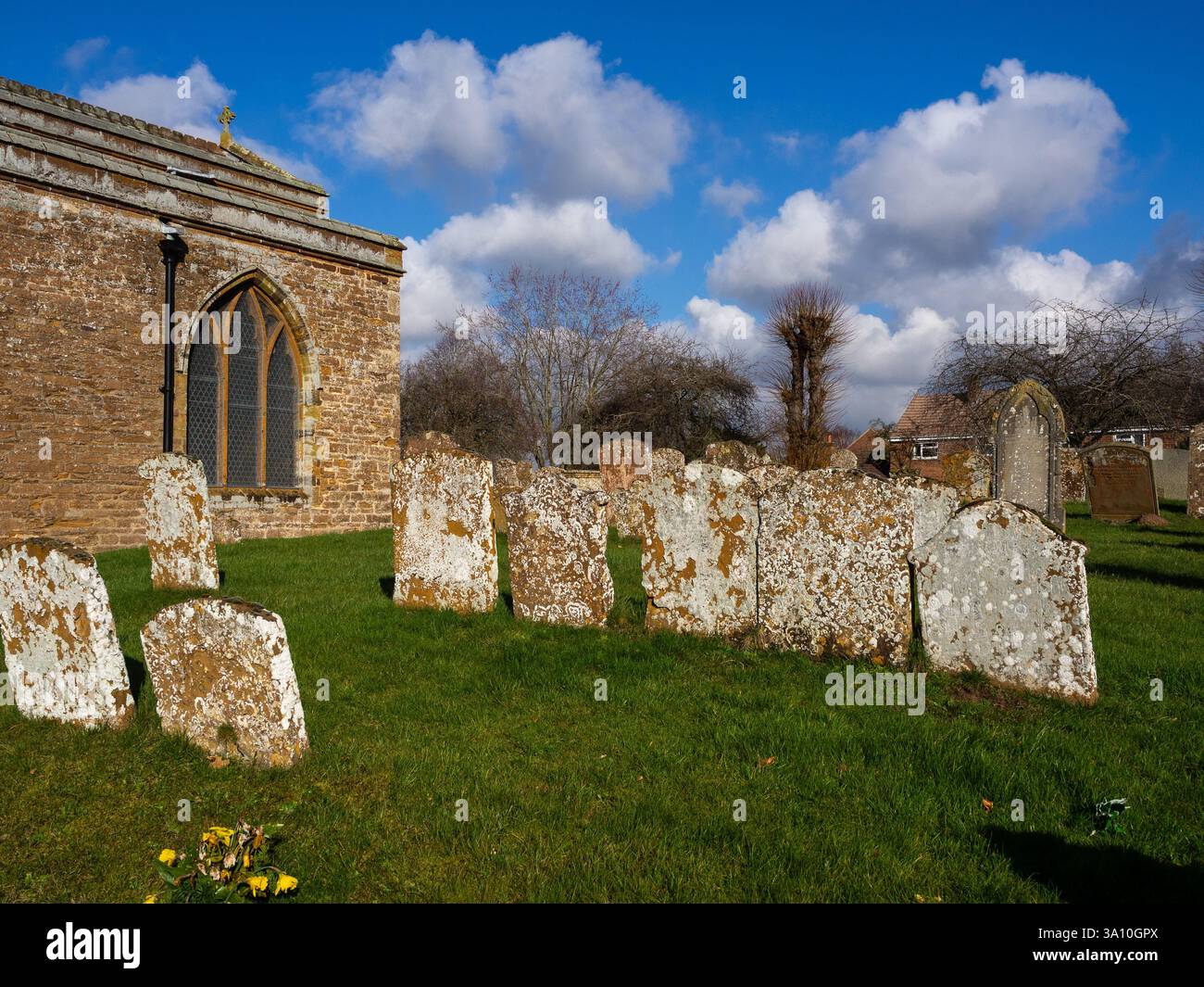 Old weathered gravestones in the churchyard of the church of the Holy ...