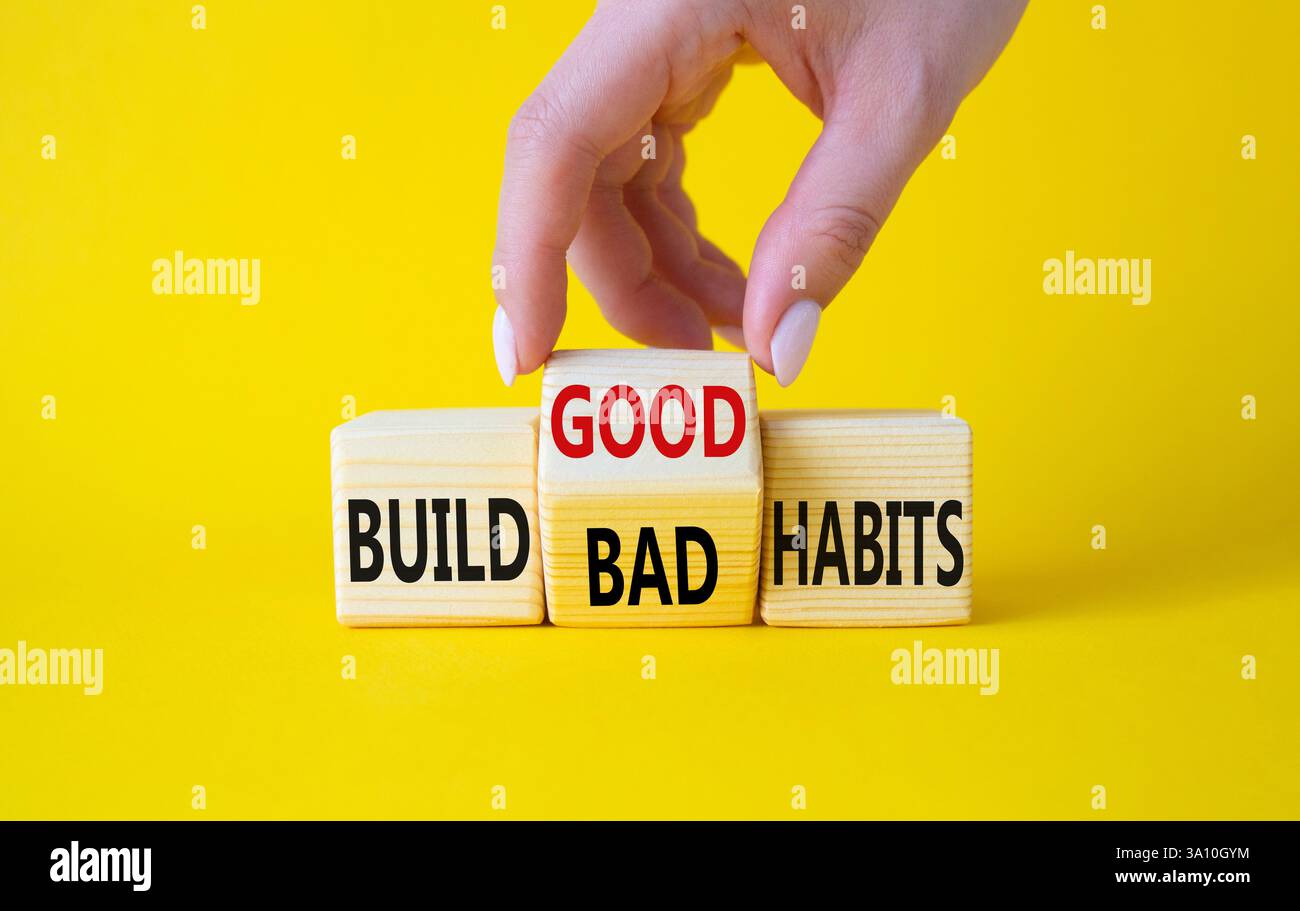 Build Good or Bad Habits symbol. Businessman hand turns wooden cubes ...