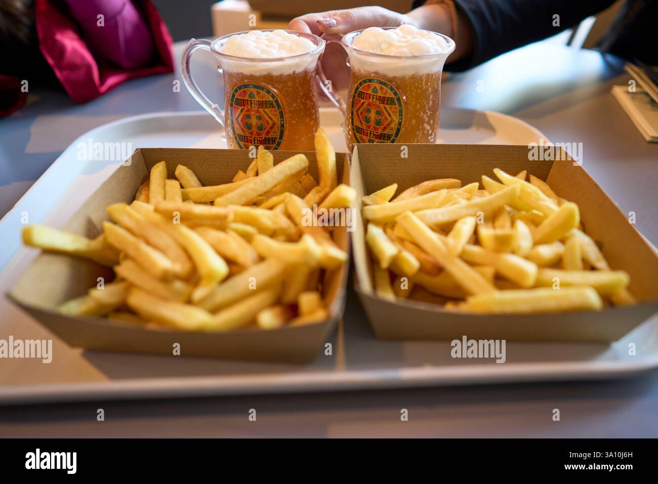 Two servings of french fries and frothy drinks on a tray in a casual dining setting Stock Photo ...