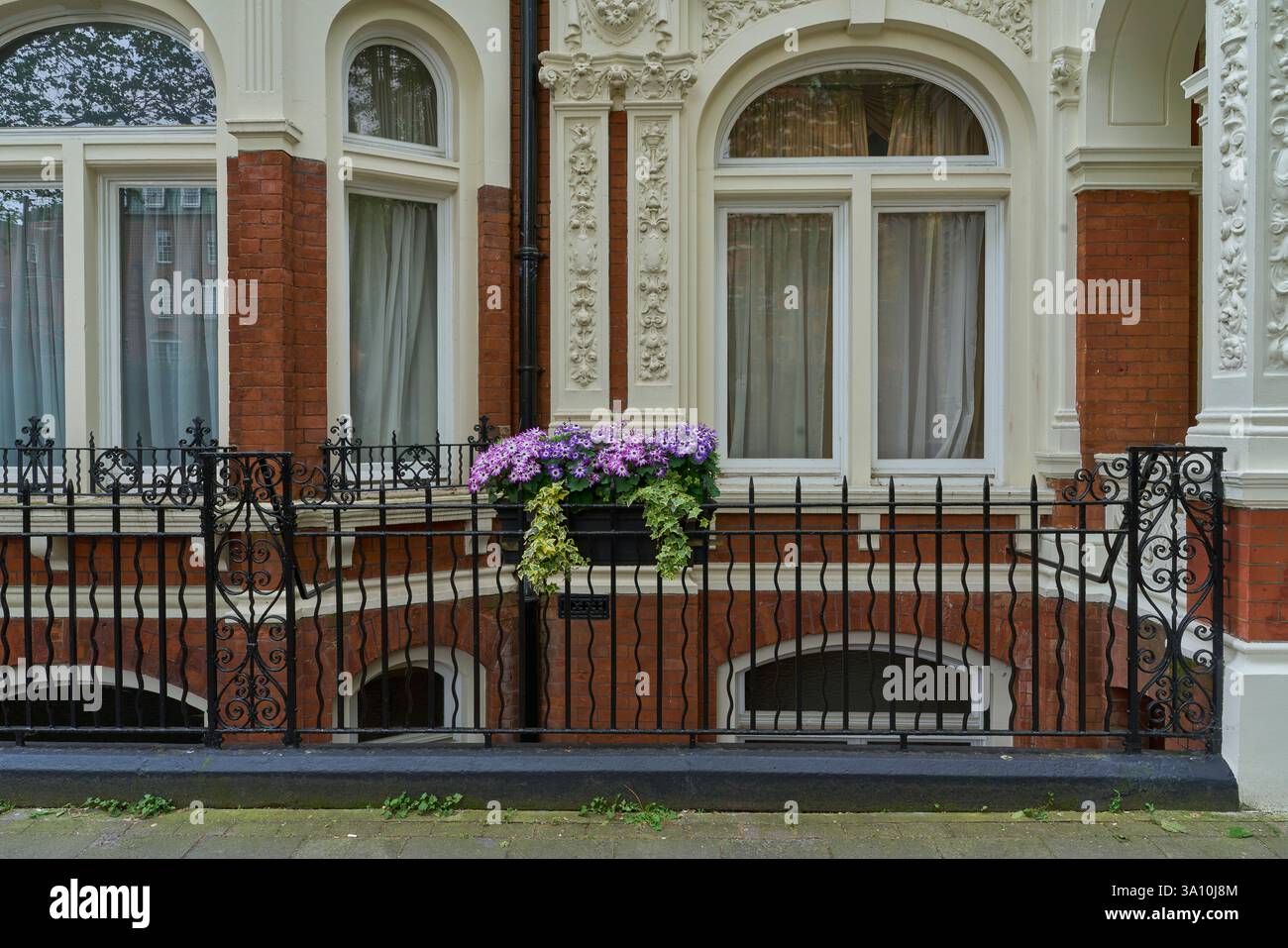 A detailed view of a classic Victorian-style building facade with ...