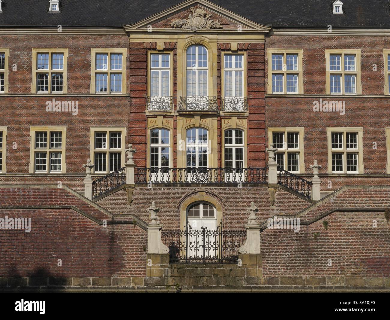 Magnificent red brick castle facade with ornate windows and symmetrical ...