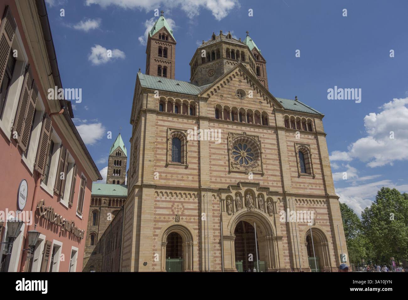 Facade of a Romanesque church with towers and rose window under a clear ...