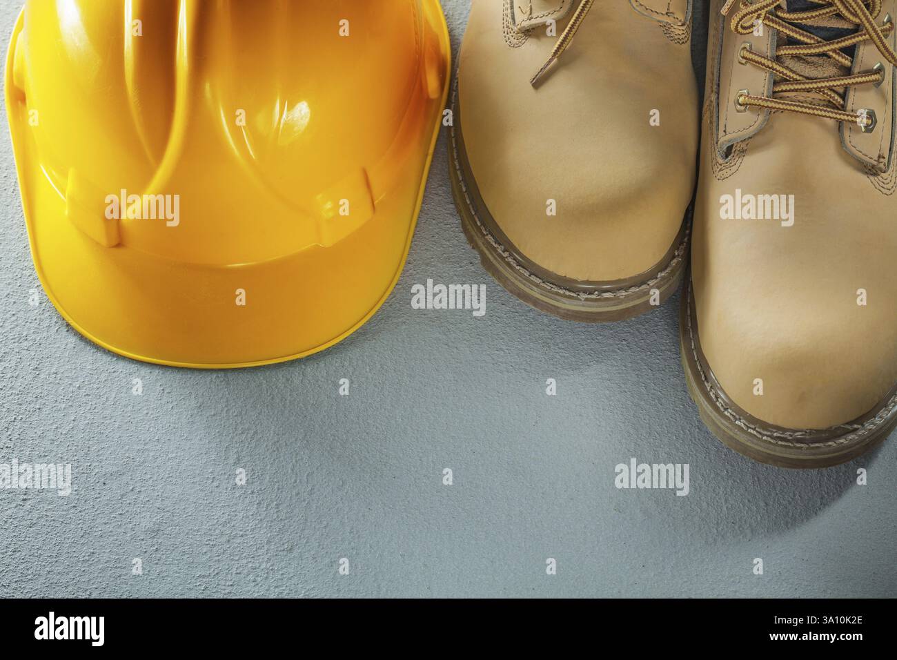 Building helmet waterproof safety boots on concrete background Stock ...