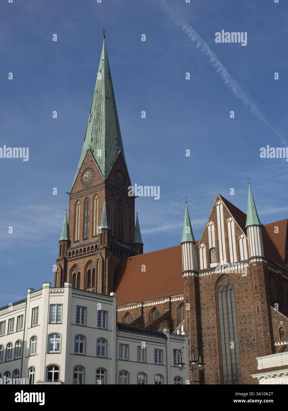 High brick church with pointed roof and towers on a clear day, Schwerin ...