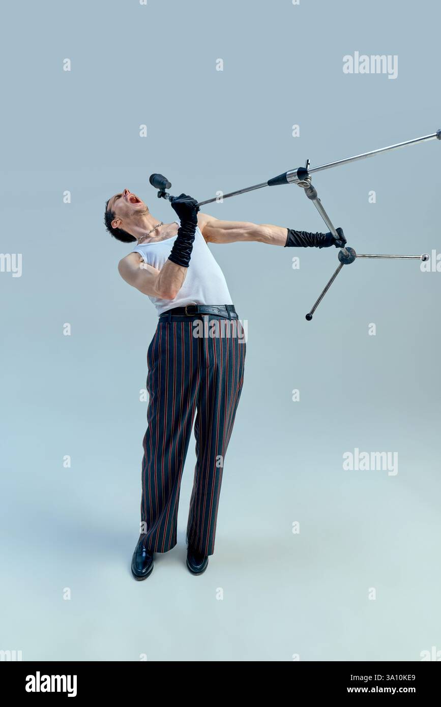 Talented vocalist pushing boundaries, microphone stand twisting mid-air ...