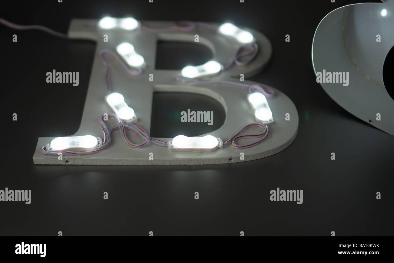 Glowing LEDs on the back of a lighted letter used to make advertising ...