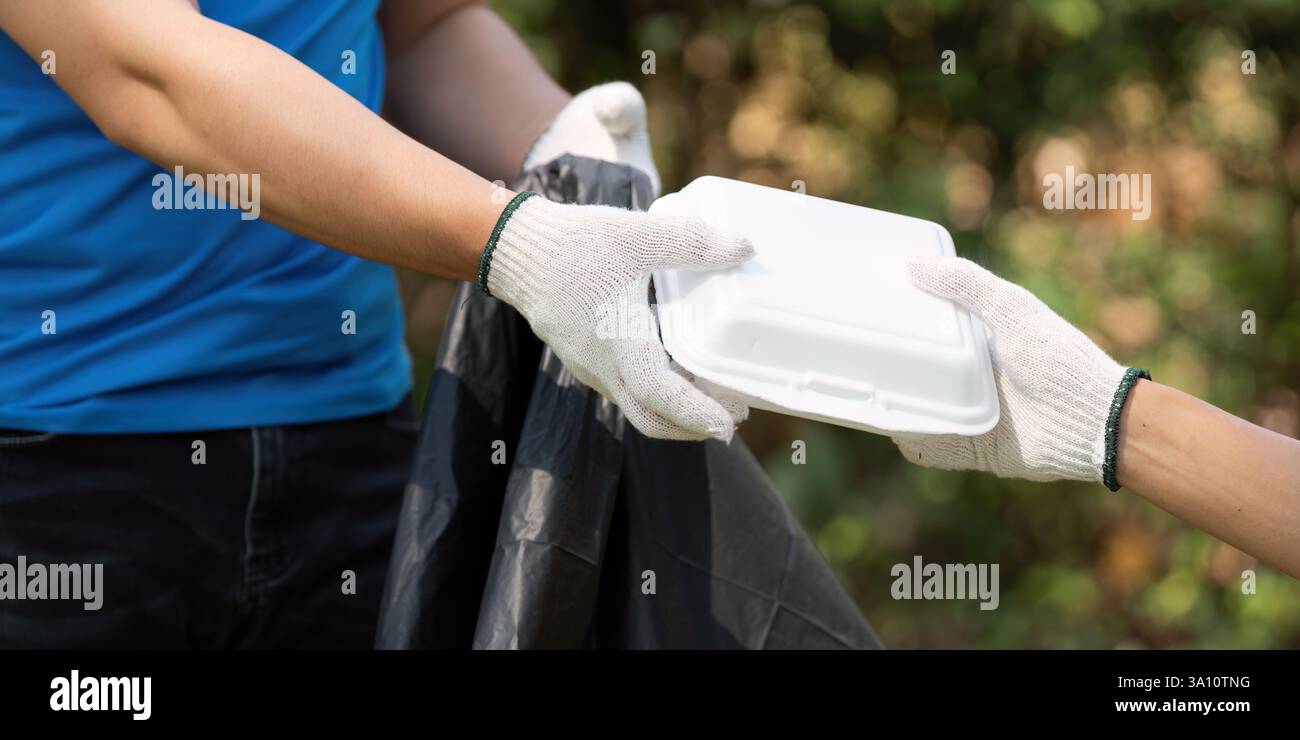 Volunteers collecting waste in a park, promoting sustainability and ...