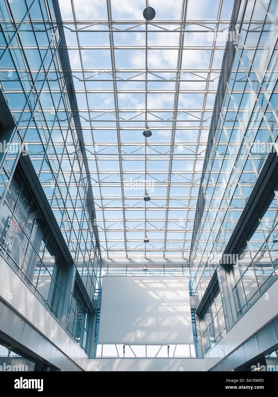 Modern airport terminal interior. Looking up at the sky through a glass ...