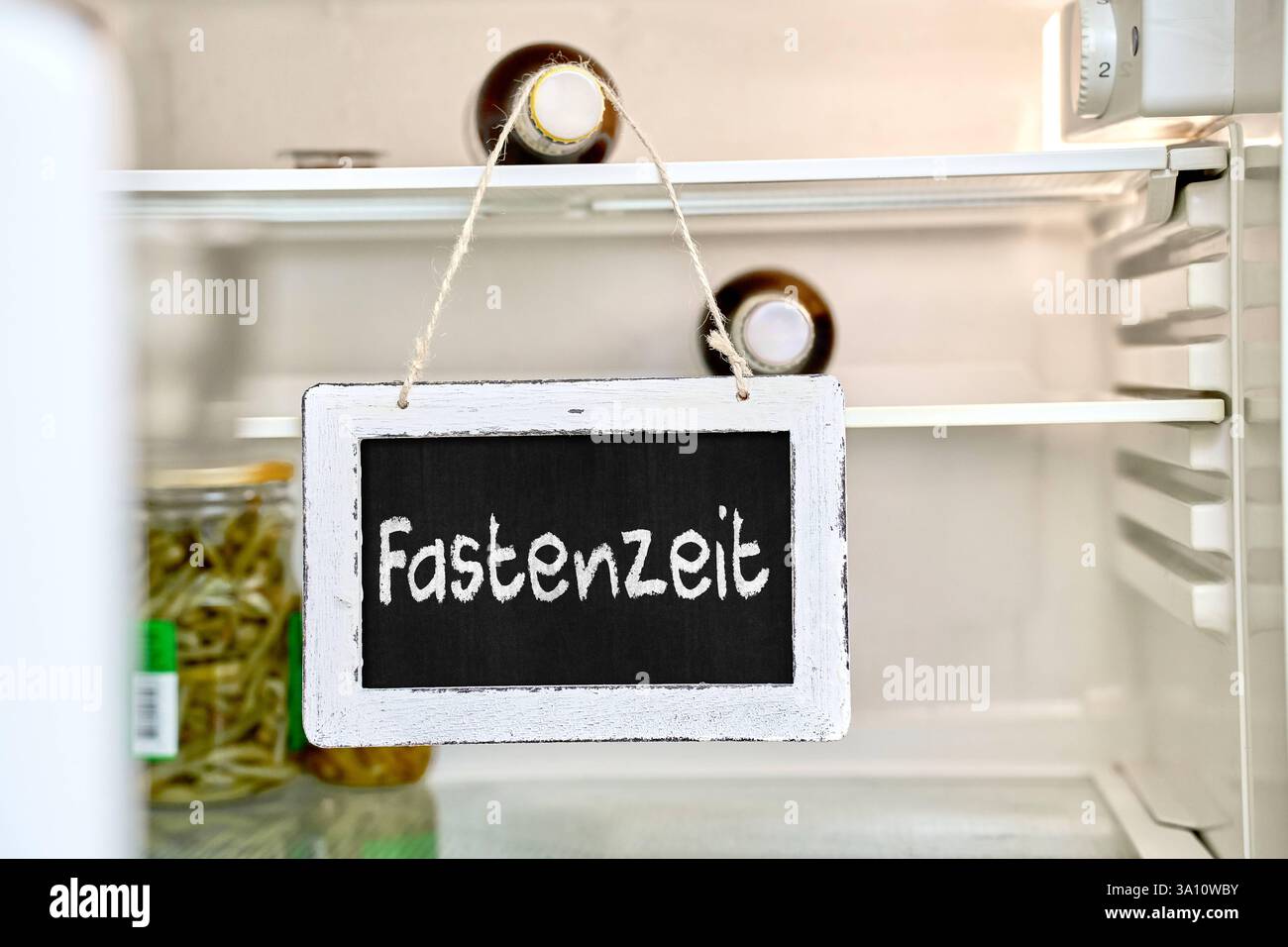 Germany - March 5, 2025: FOTOMONTAGE, An empty refrigerator with a sign ...