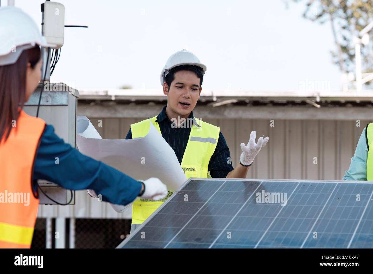 Engineer presenting solar project details to team members at a ...