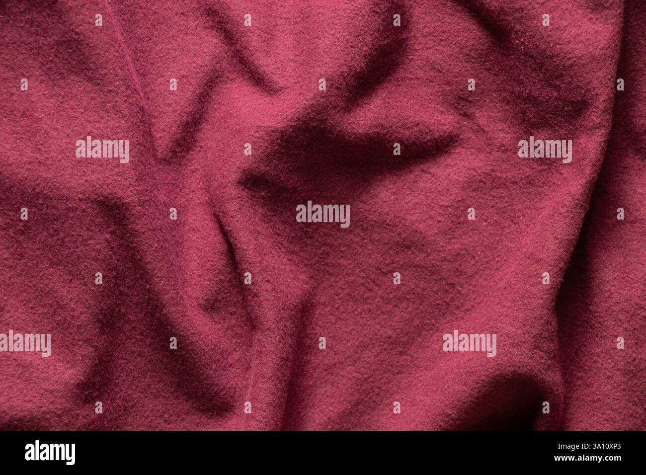 Red synthetic fabric fleecy with folds as background, red soft warm ...