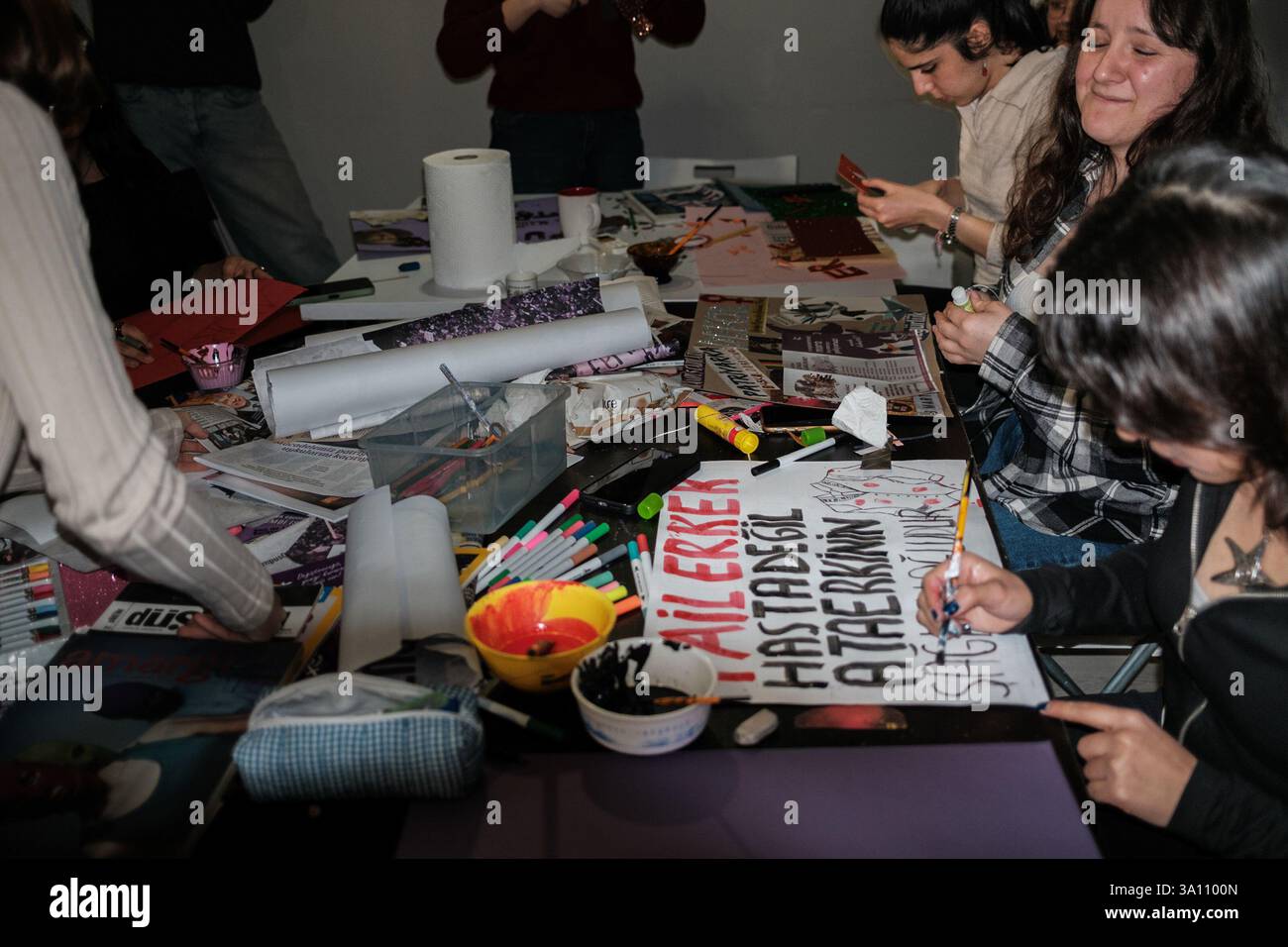 Women preparing banners at a table. Feminist women organized a banners ...