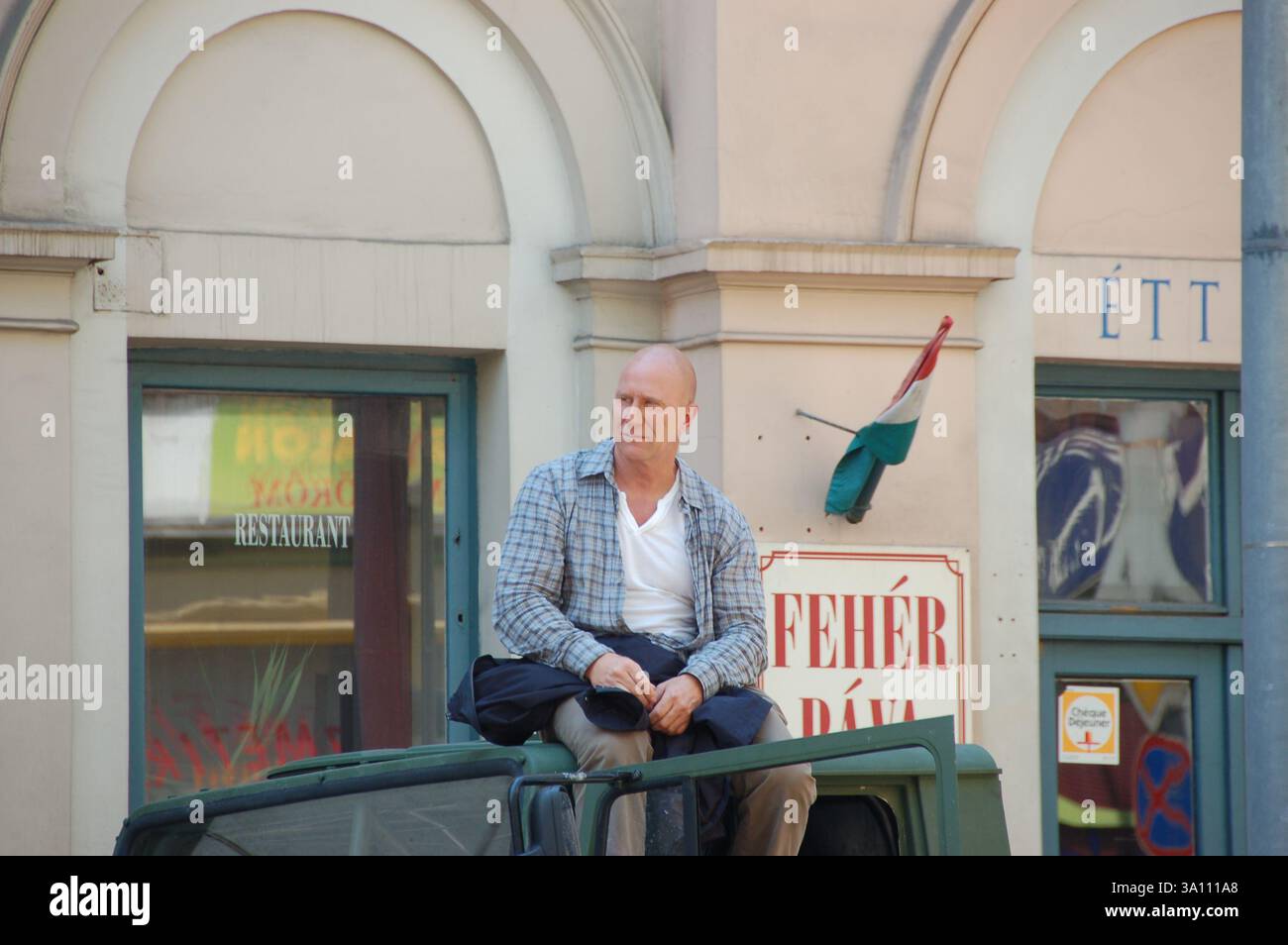 Stuntman Larry Rippenkroeger sits on top of a military-style vehicle ...