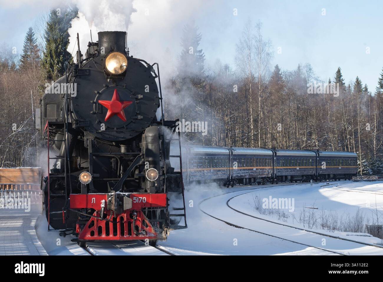 RUSKEALA, RUSSIA - FEBRUARY 20, 2025: Steam locomotive L-5170 with the retro train "Ruskeala ...