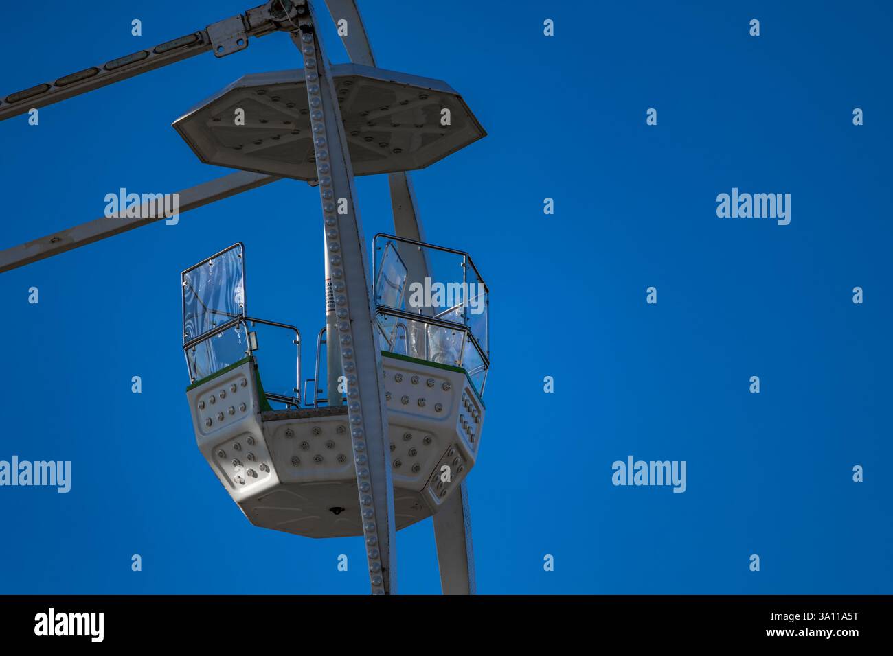 Amusement park in the city center, large ferris wheel, tall carousel ...