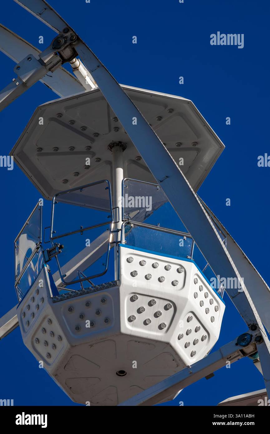 Amusement park in the city center, large ferris wheel, tall carousel ...