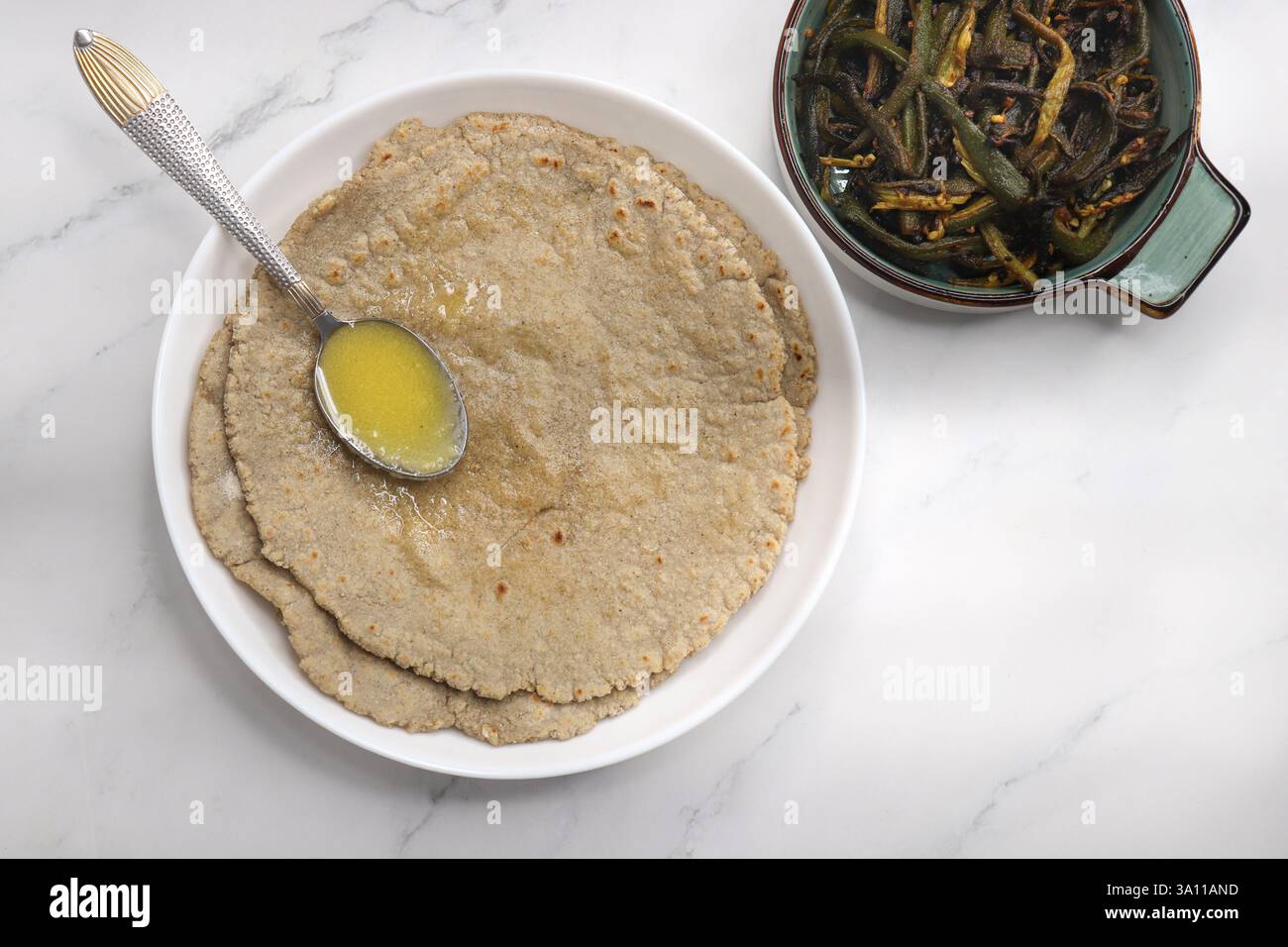 Jowar flour flatbread known as bhakar or jawari bhakri. served with ...