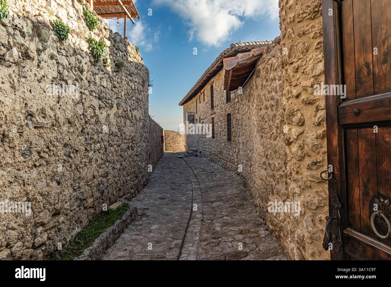 Rural and traditional village in Europe. A narrow cobblestone street ...