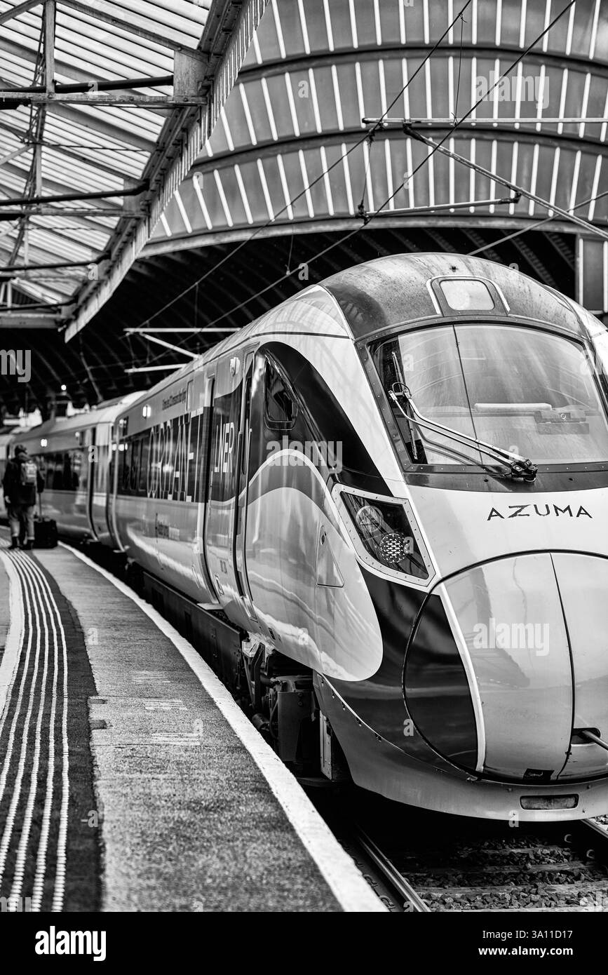 A train stands at a historic 19th Century platform with a metal and ...