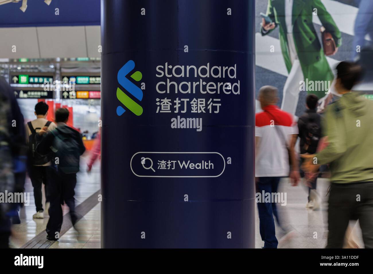 Hong Kong, China. 05th Mar, 2025. People walk past a large ...