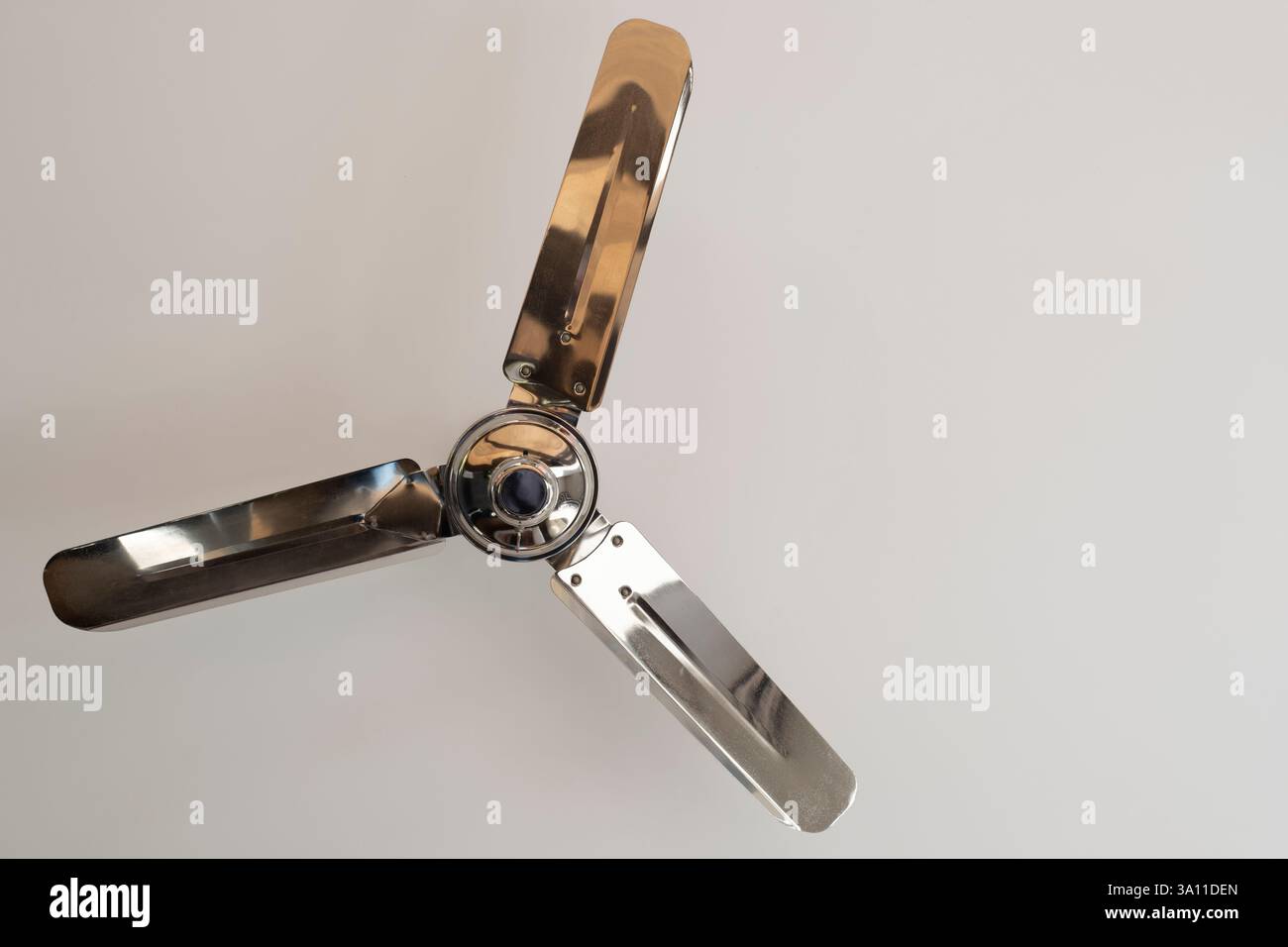 Shiny ceiling fan on light gray background. Seen from below Stock Photo ...