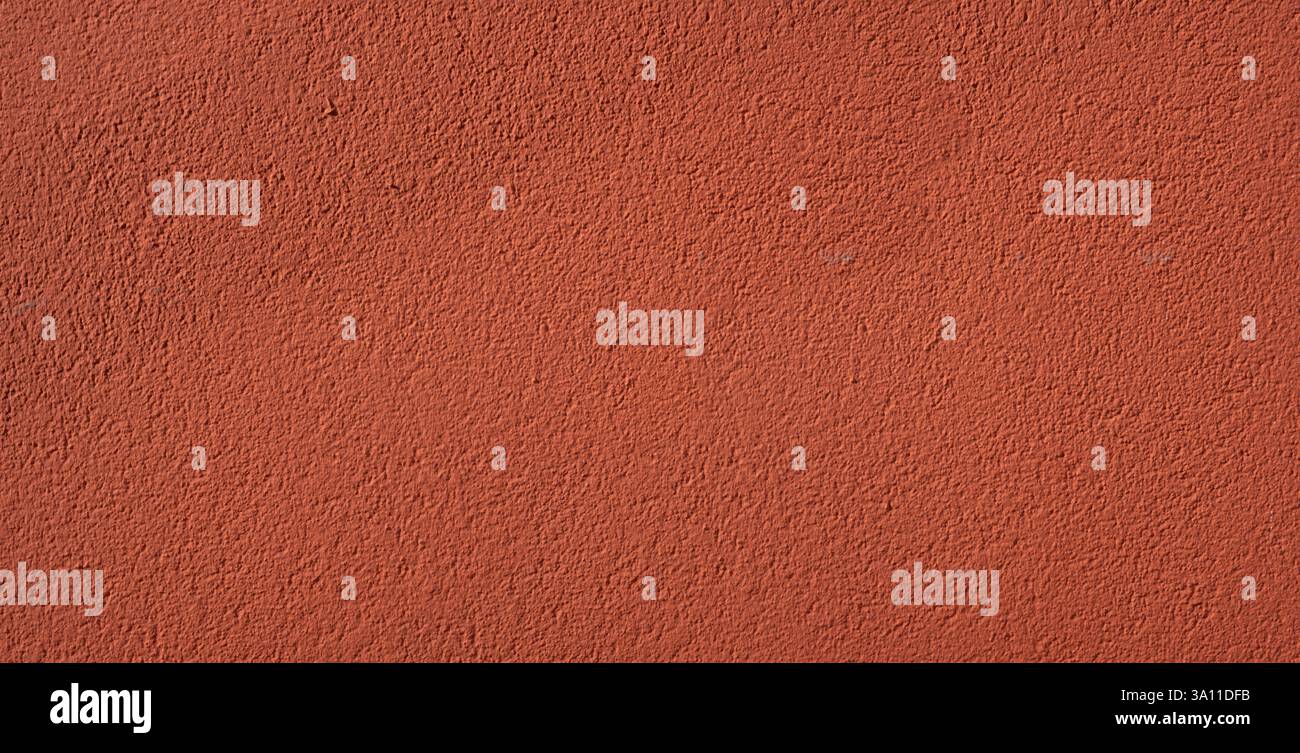 Background of red decorative plaster, with pits and grooves in random ...