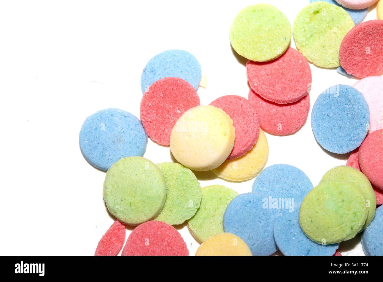 Close up of sugar paper confetti circle spots and colour dots on white ...
