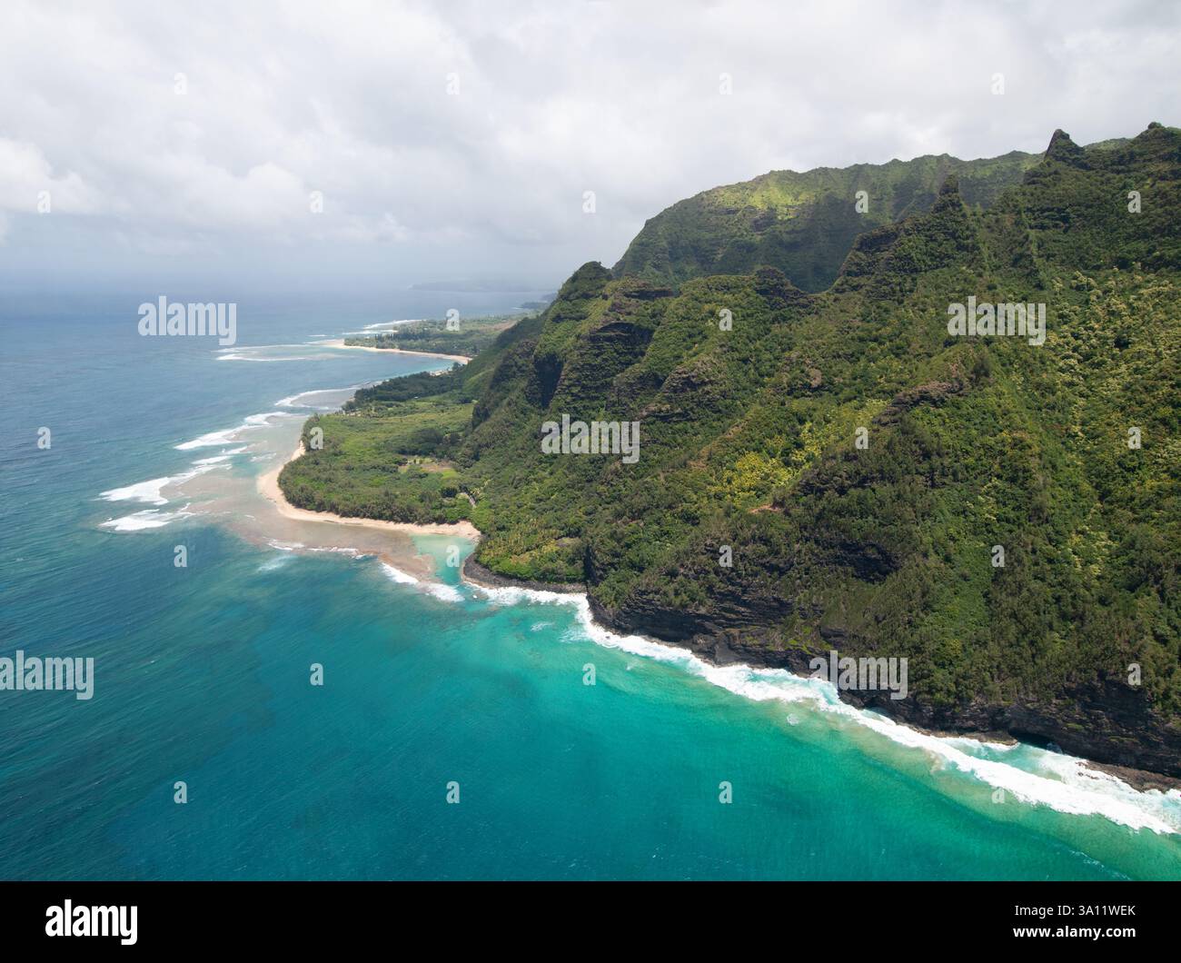 Aerial view of the Na Pali Coast in Kauai Hawaii featuring steep green ...