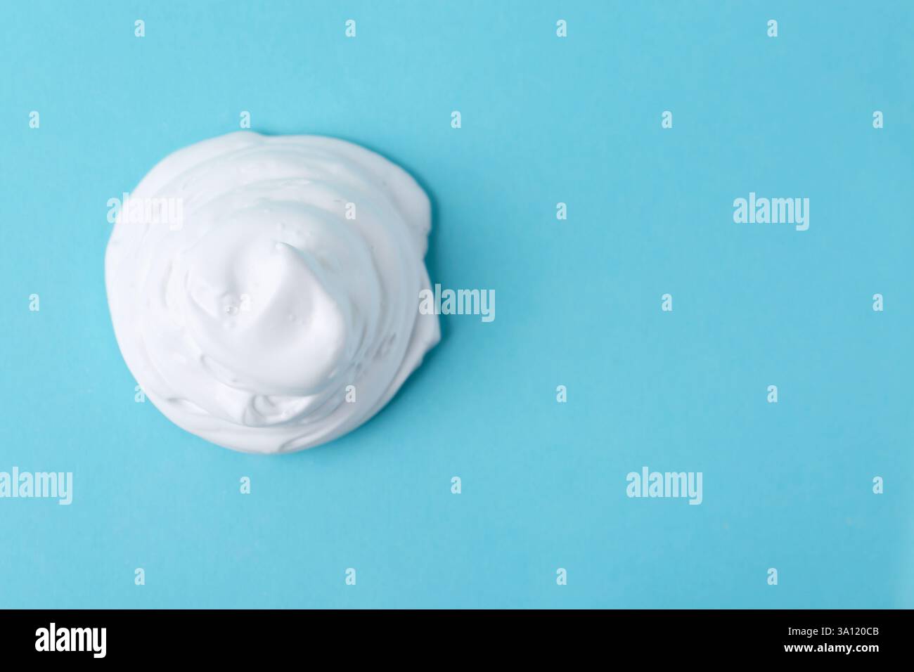 Sample of fluffy foam on light blue background, top view. Space for ...