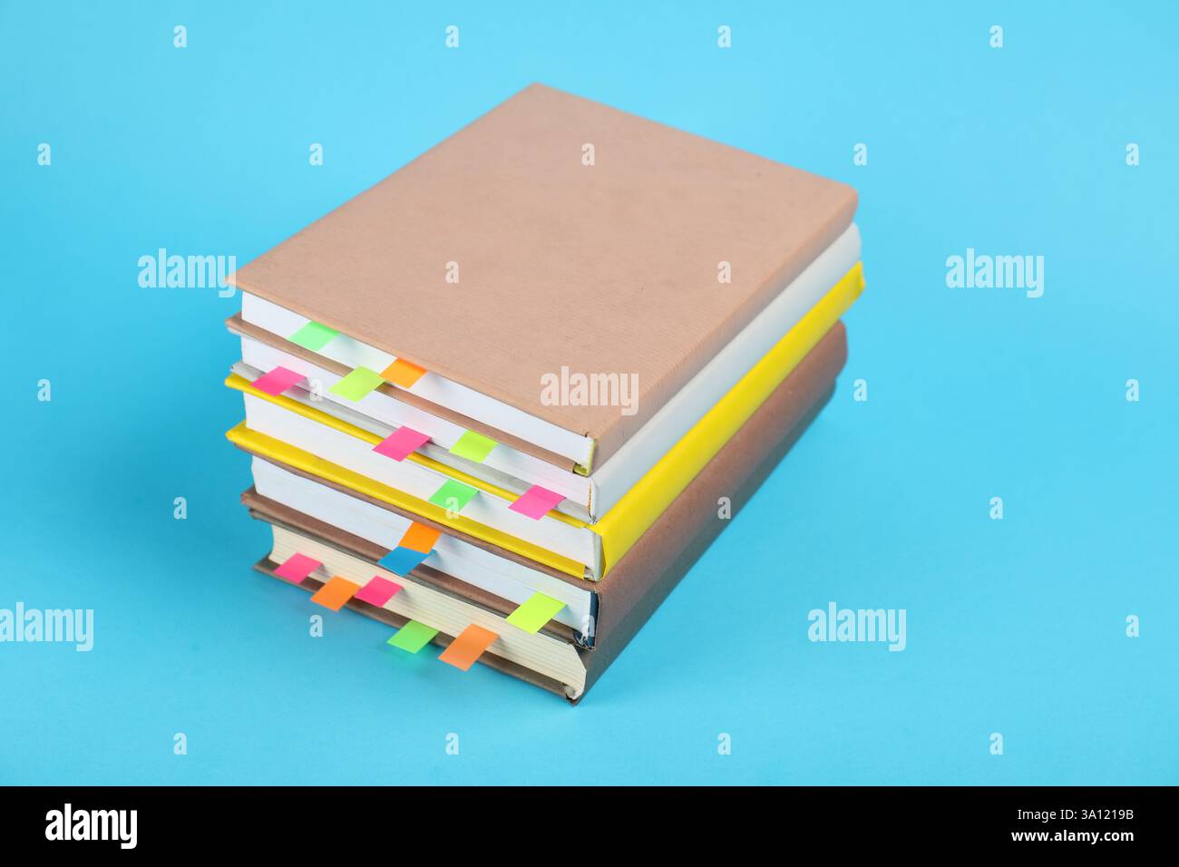 Books with colorful tabs on light blue background Stock Photo - Alamy