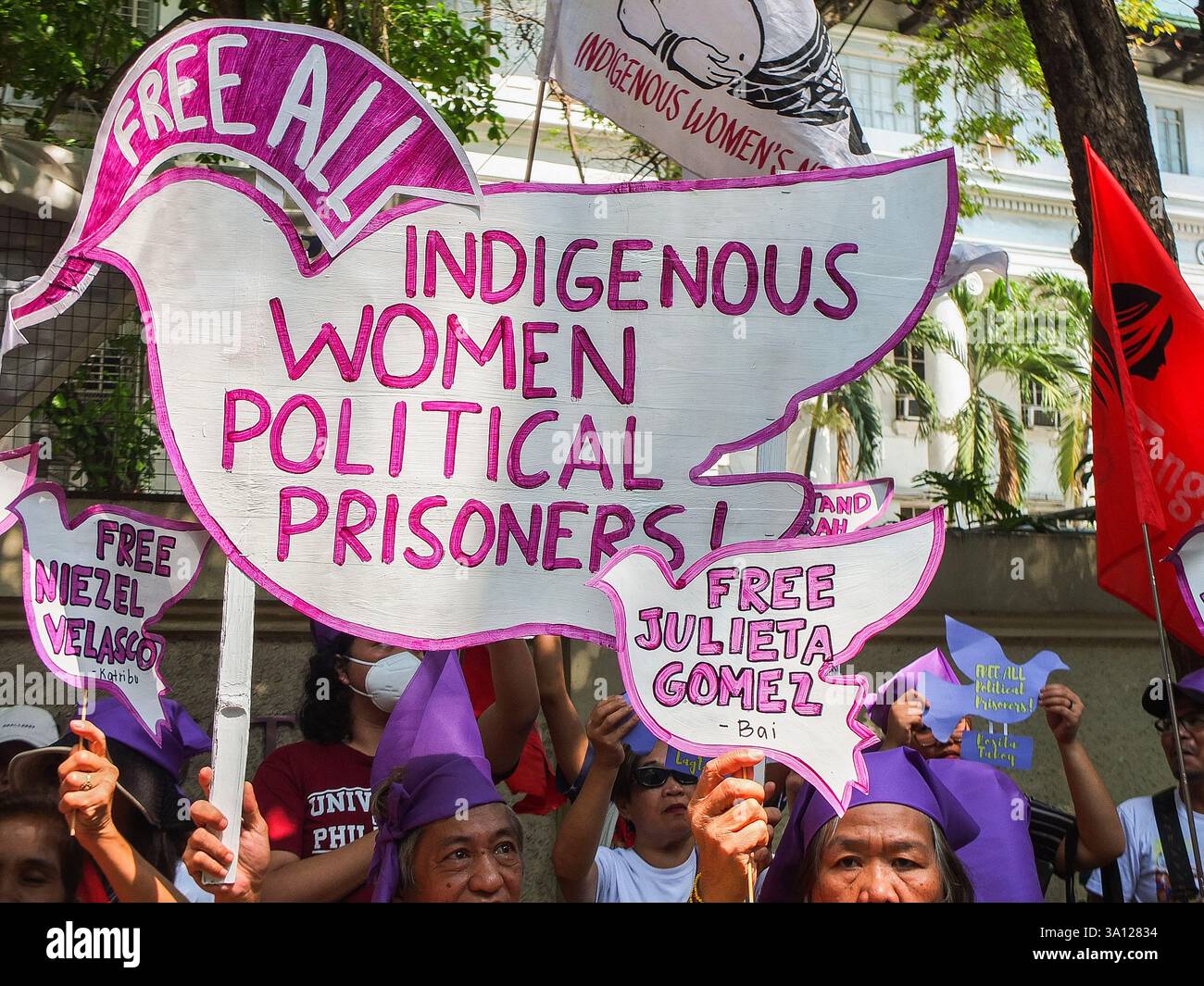 Women activists holding a large purple dove-shape placard during the ...