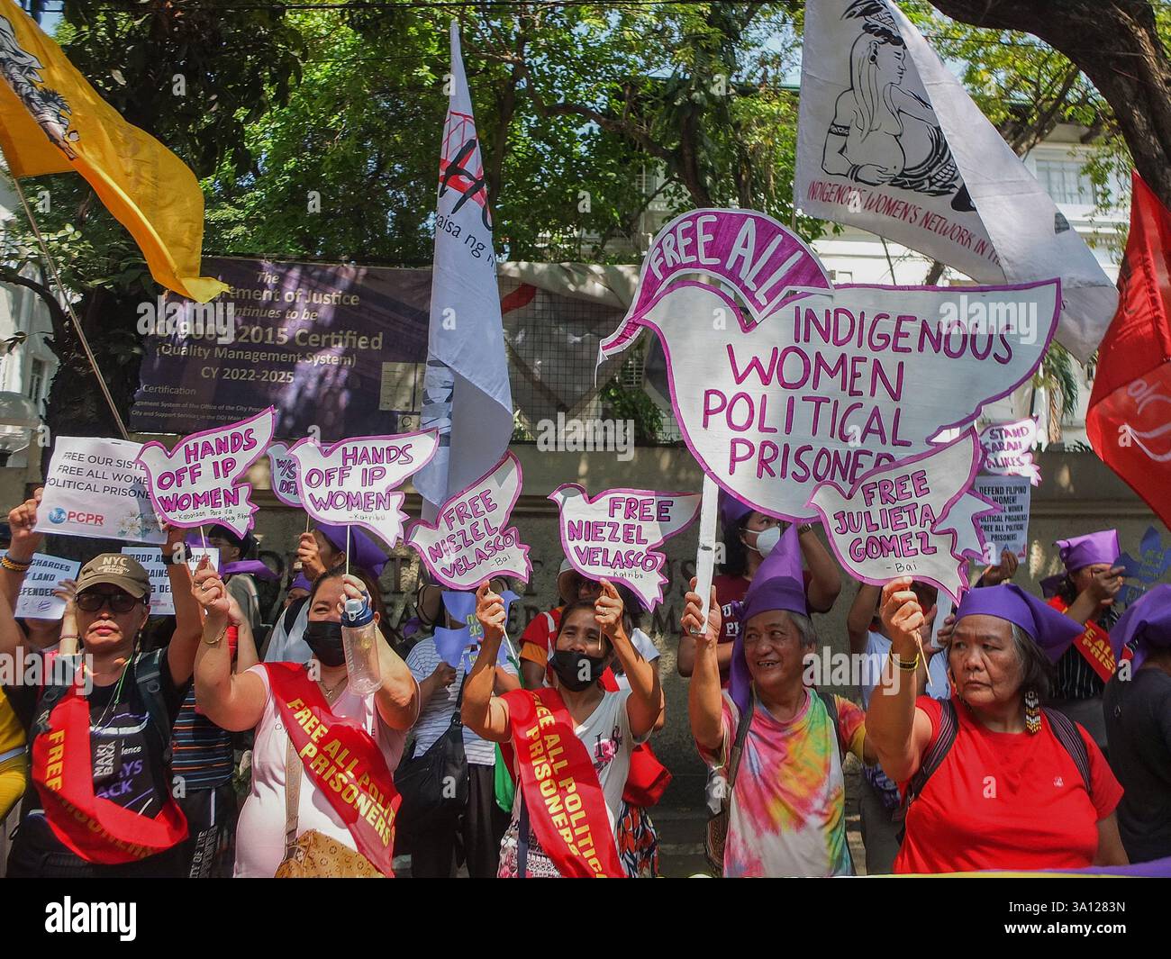 Women activists raise their placards and streamers in calling for the ...