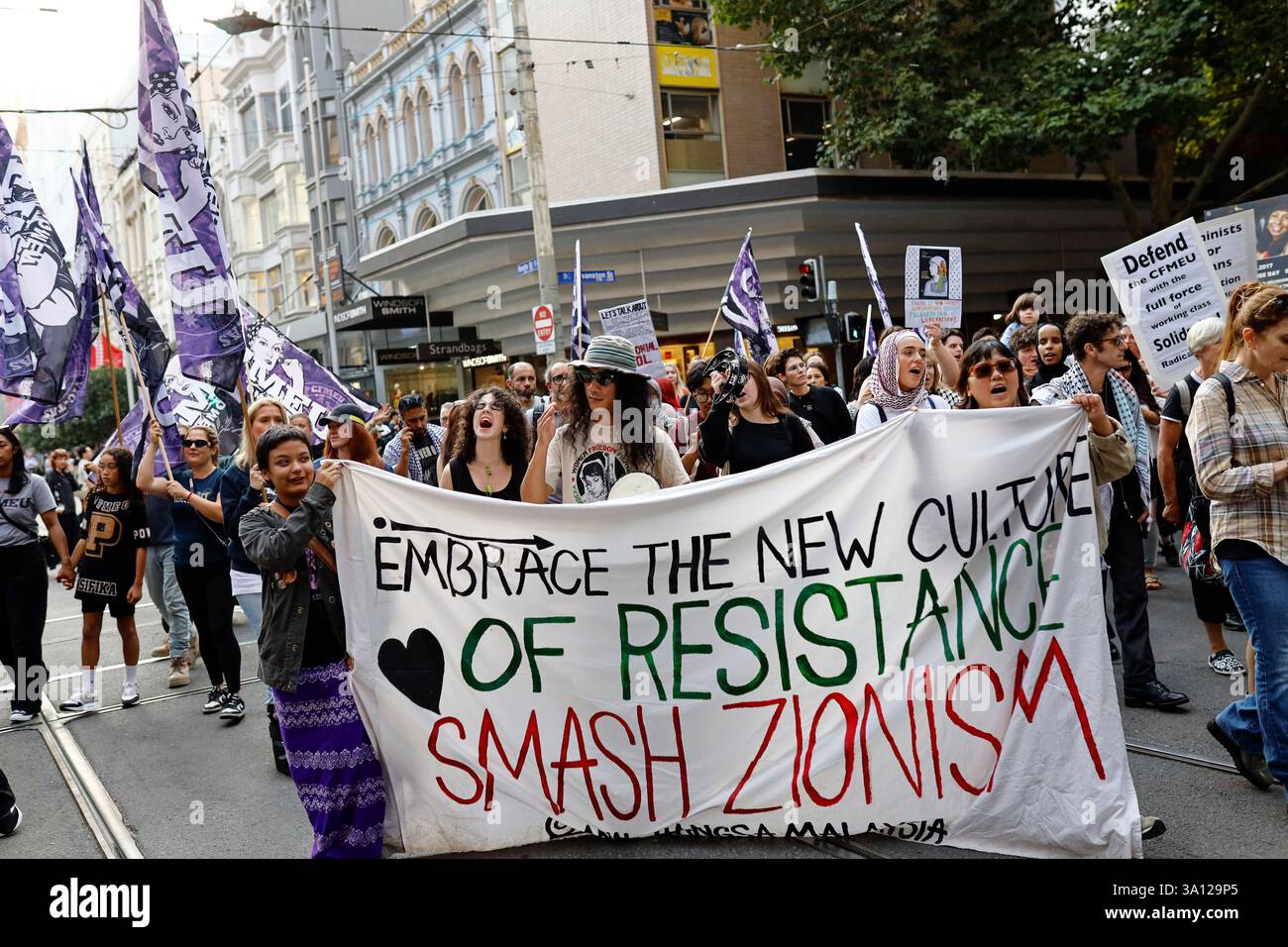 Participants hold banners expressing their demands during the ...
