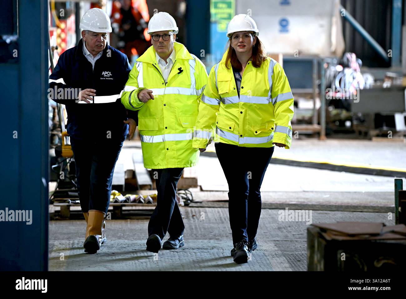 Prime Minister Sir Keir Starmer (centre) walks through a construction ...